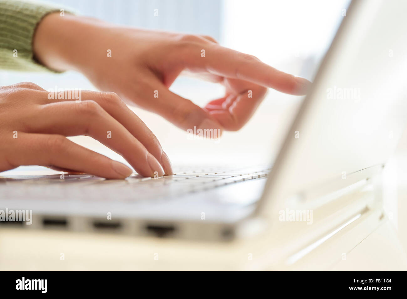 Hand typing at laptop Stock Photo - Alamy