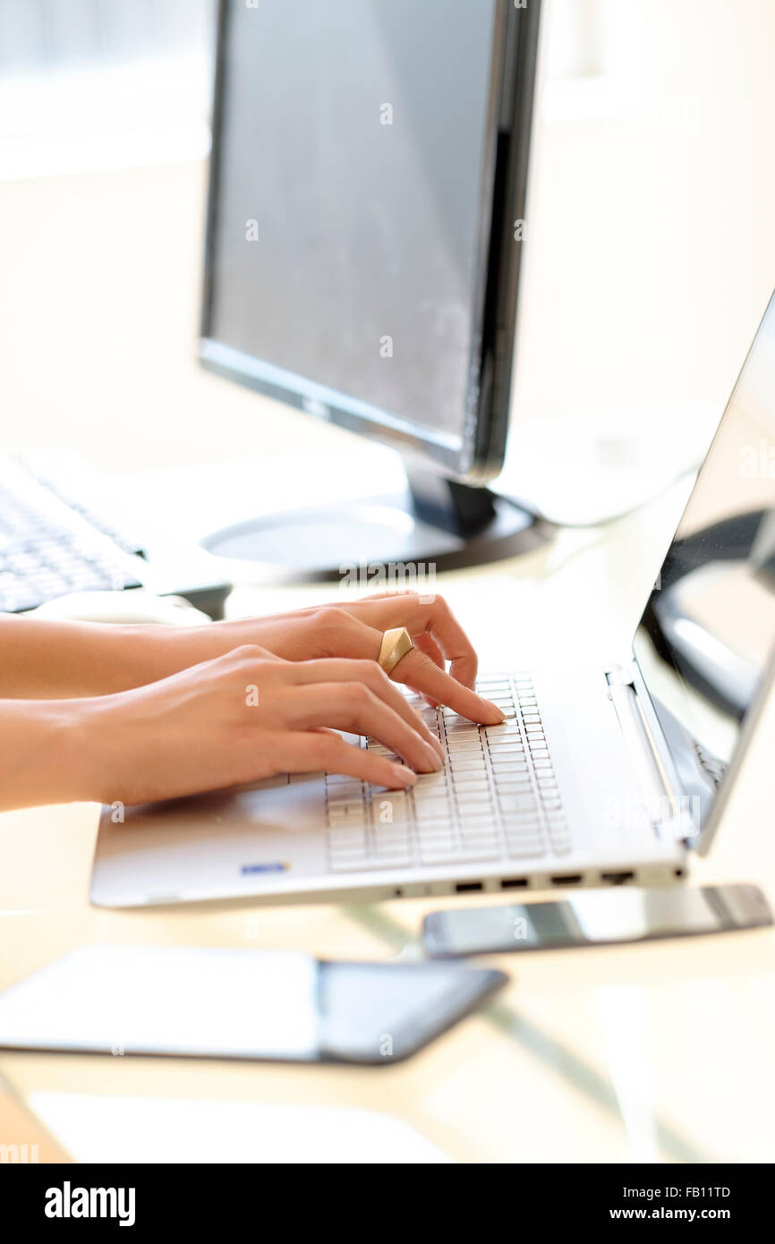 Hands typing on laptop keyboard Stock Photo - Alamy