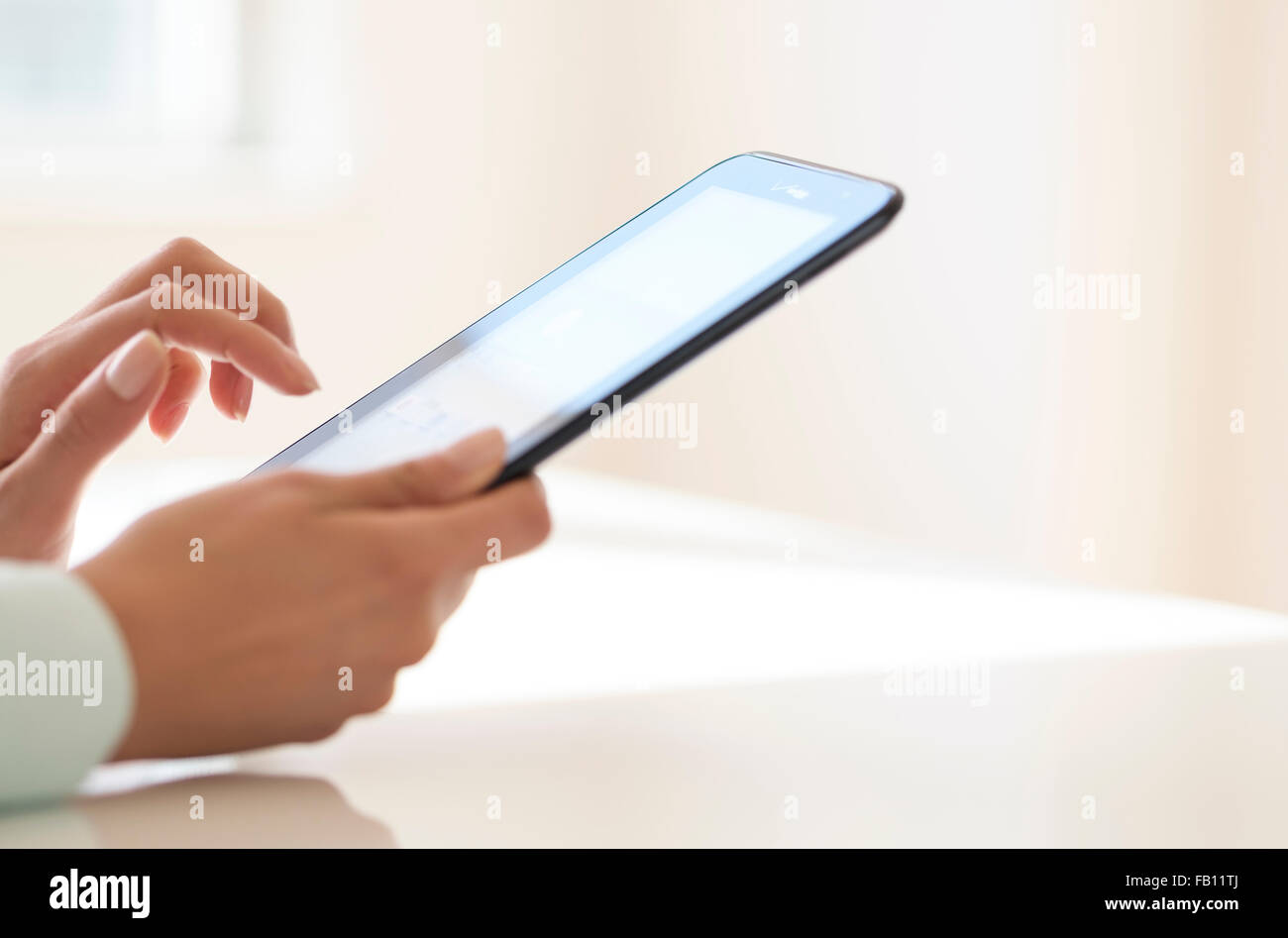 Hands using tablet pc Stock Photo - Alamy