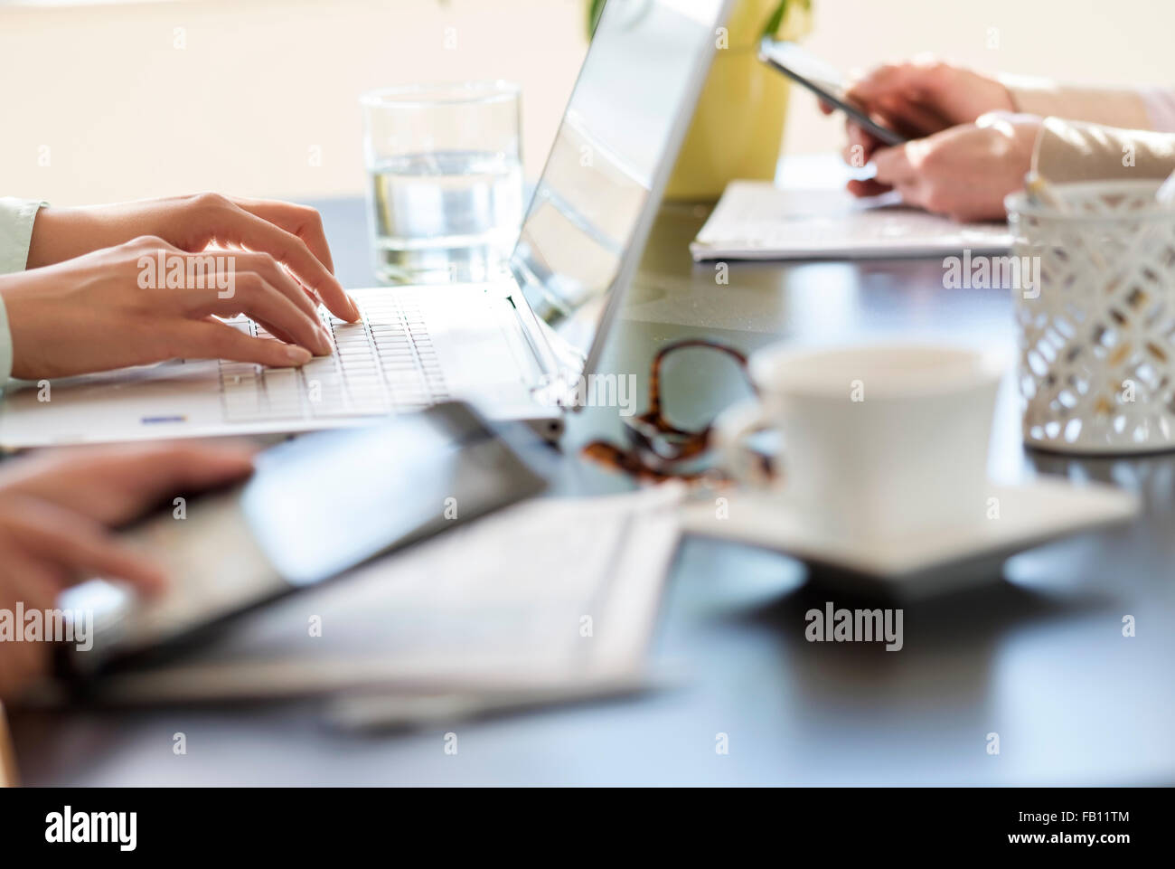 Hands using tablet pc, laptop and smart phone Stock Photo - Alamy