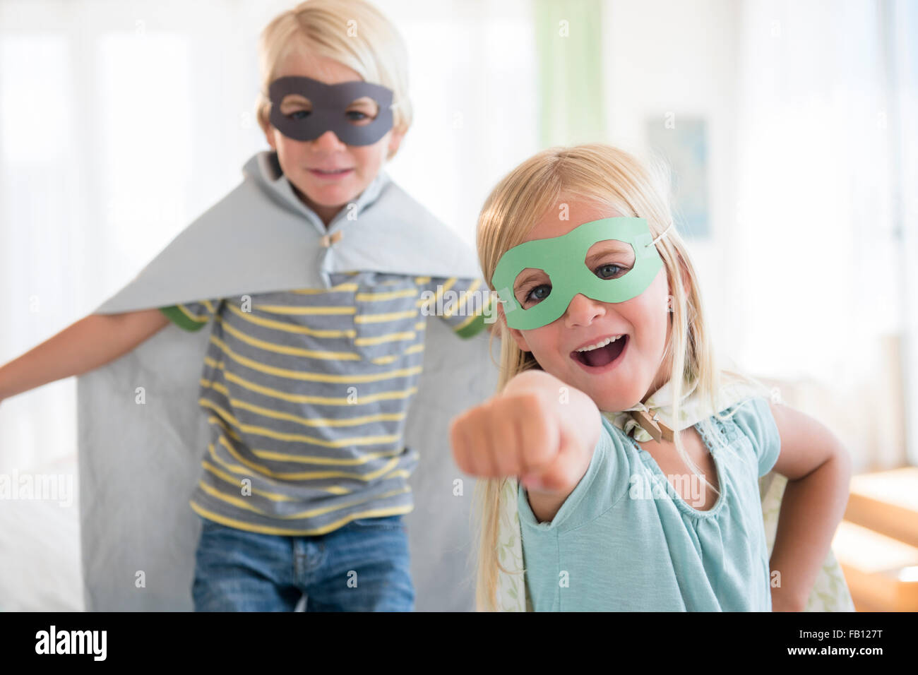 Boy (4-5) and girl (6-7) wearing masks Stock Photo - Alamy
