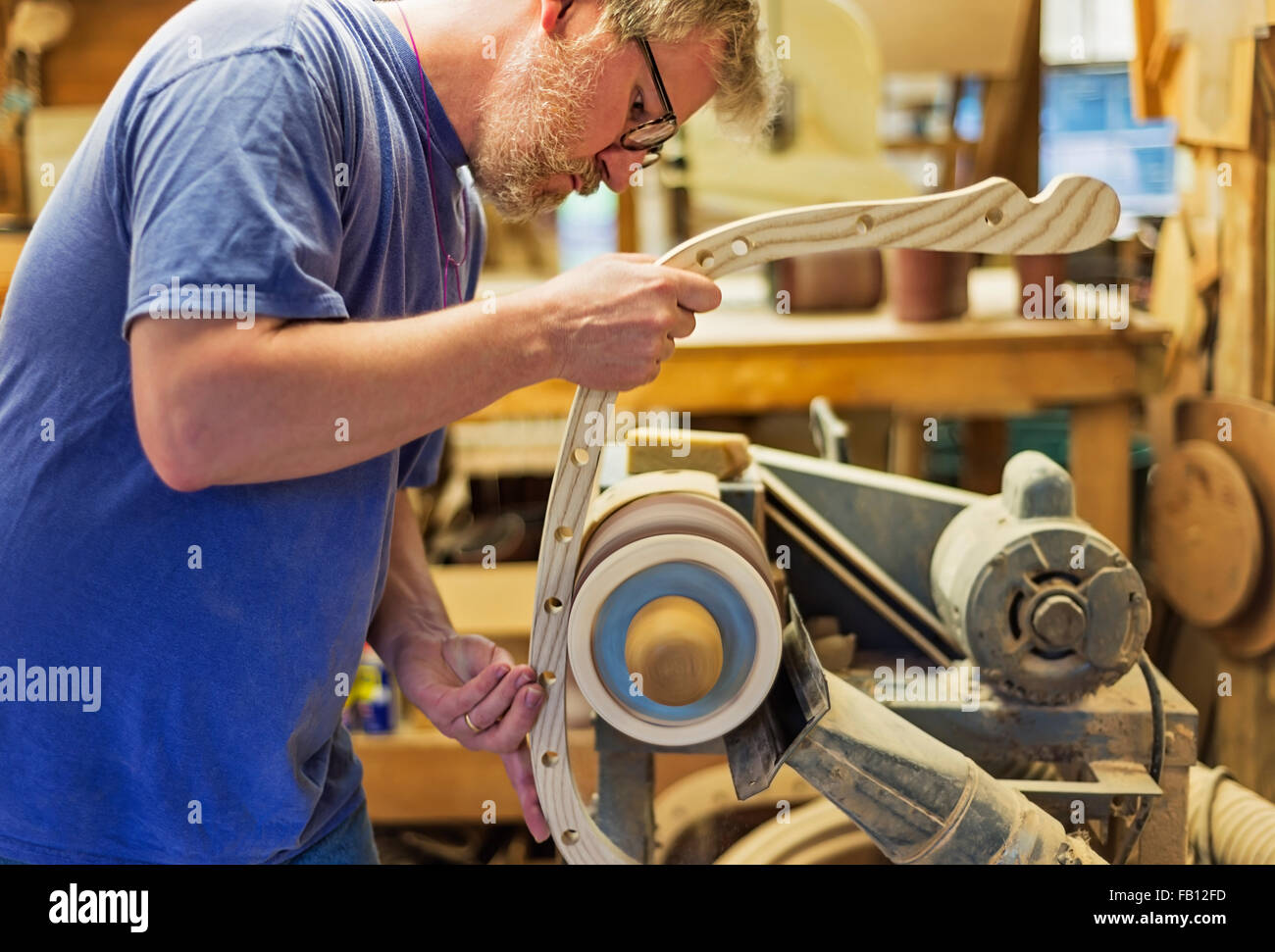 Carpenter polishing wood with sander Stock Photo - Alamy