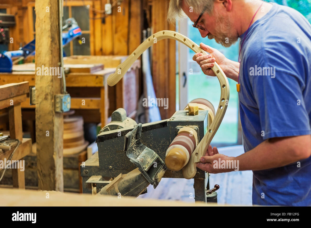 Carpenter polishing wood with sander Stock Photo - Alamy