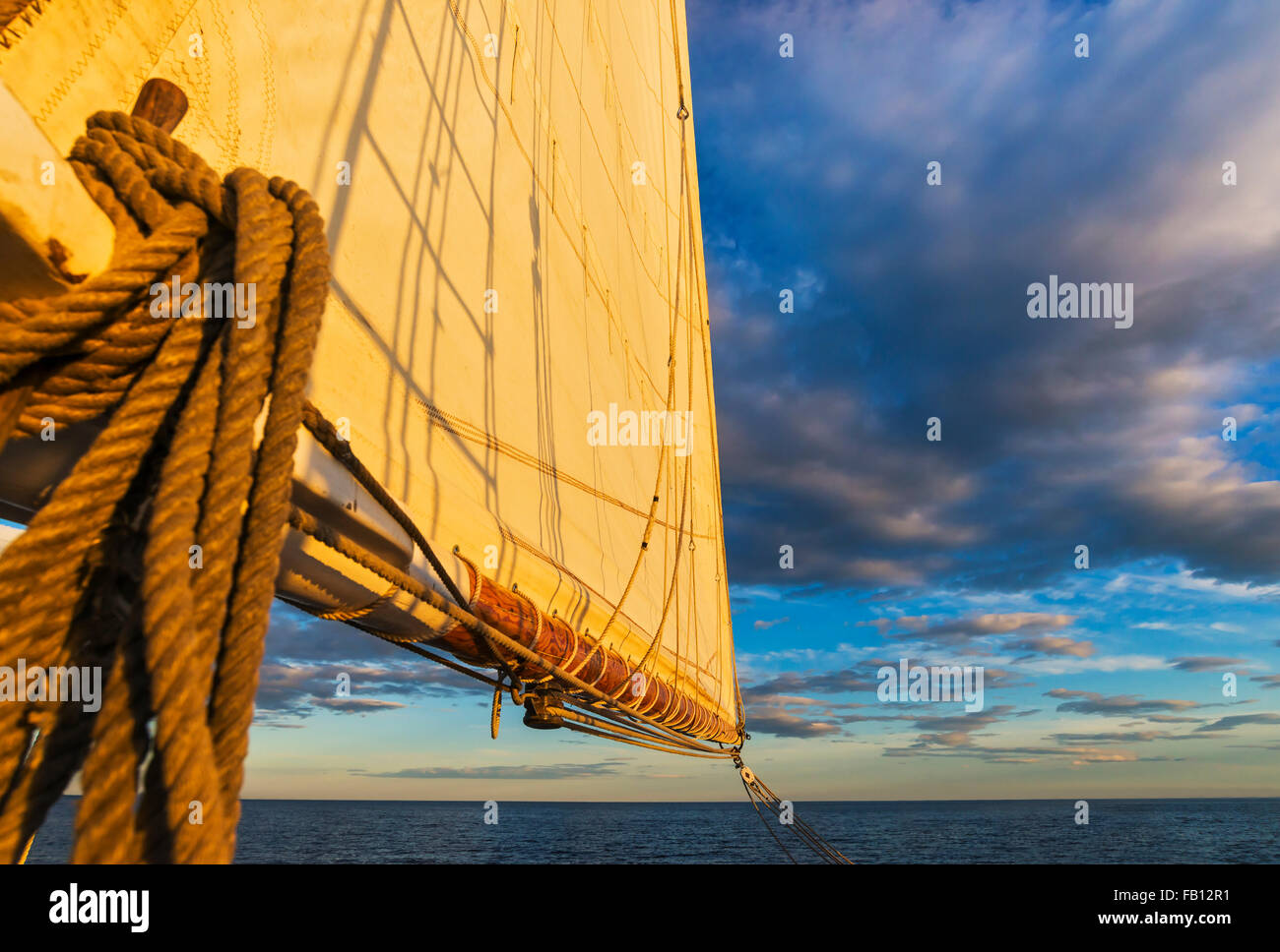 Sail and ropes against sunset sky Stock Photo - Alamy