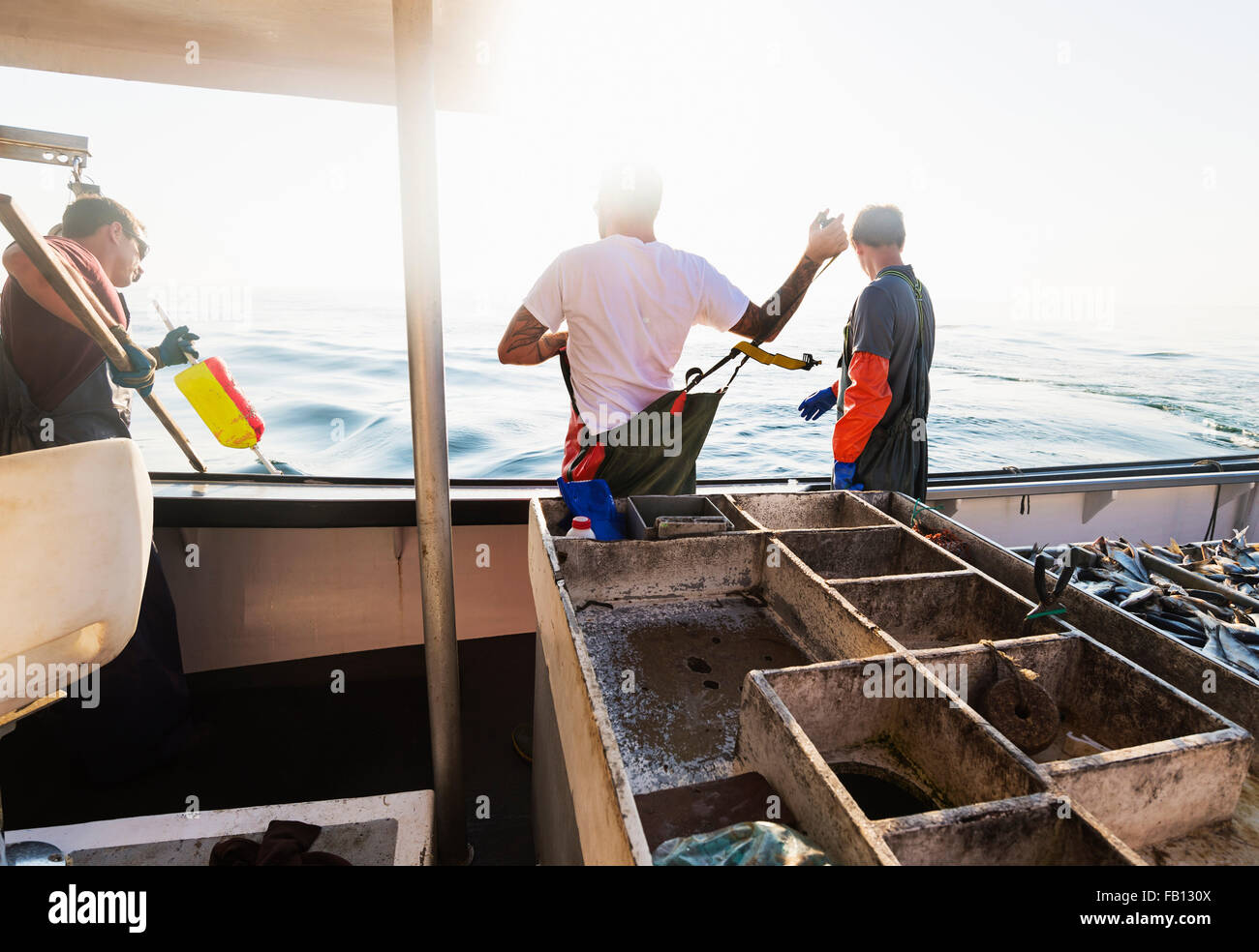 Men working on boat hi-res stock photography and images - Alamy