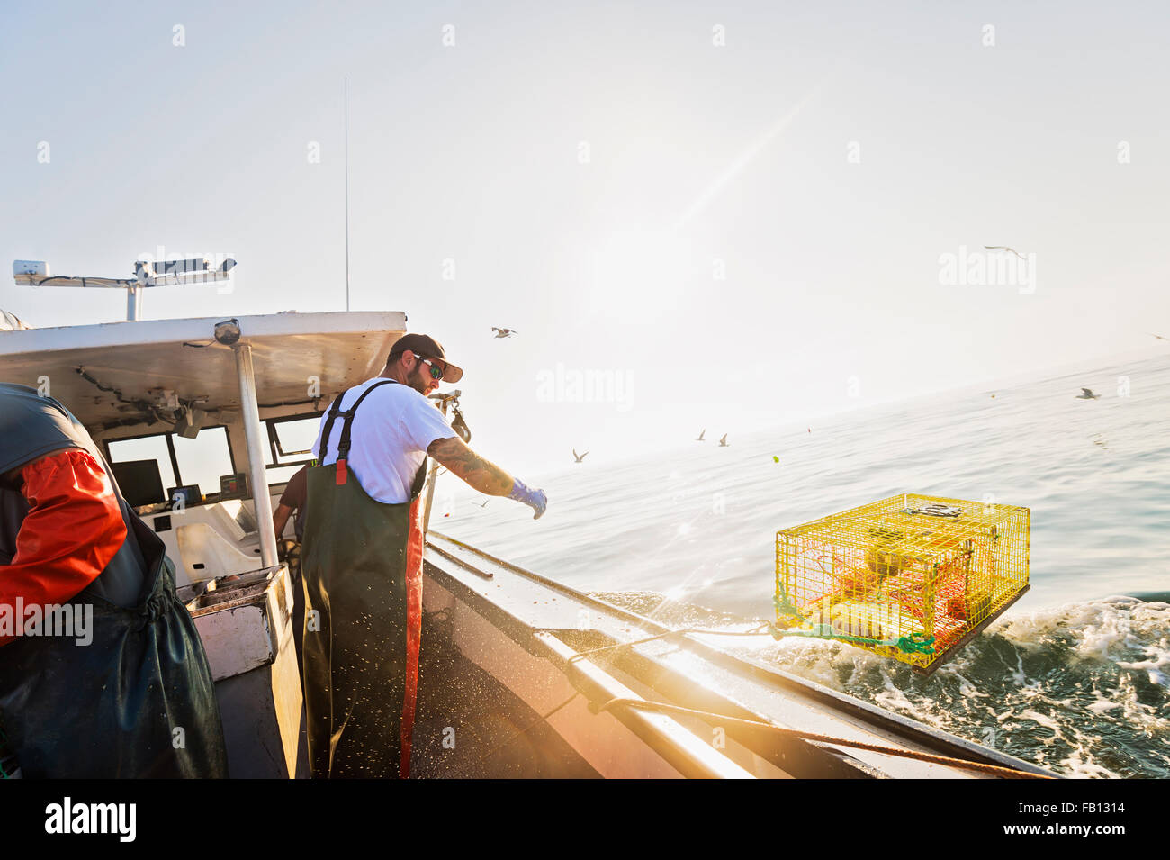 Fisherman working on fishing boat Stock Photo - Alamy