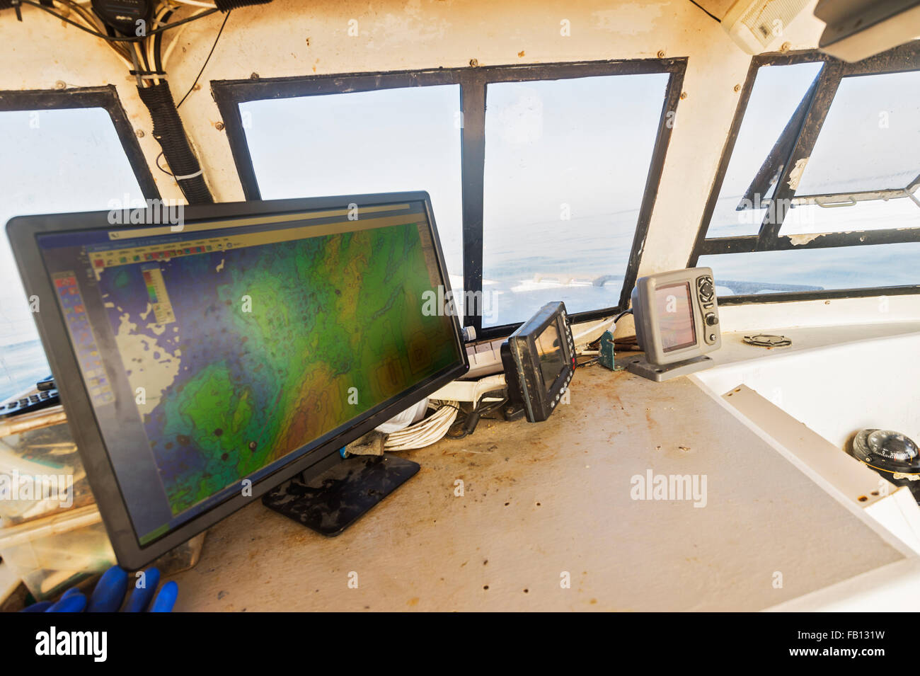 Directions on device screen inside fishing boat Stock Photo - Alamy