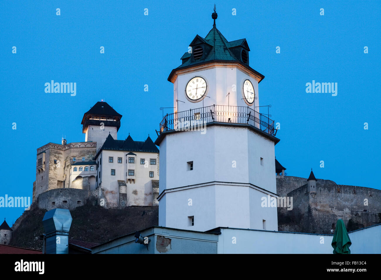 Illuminated clock tower at dusk Stock Photo - Alamy