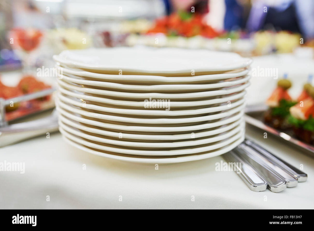 Stack of clean plates with knifes ready to be used on dinner Stock ...