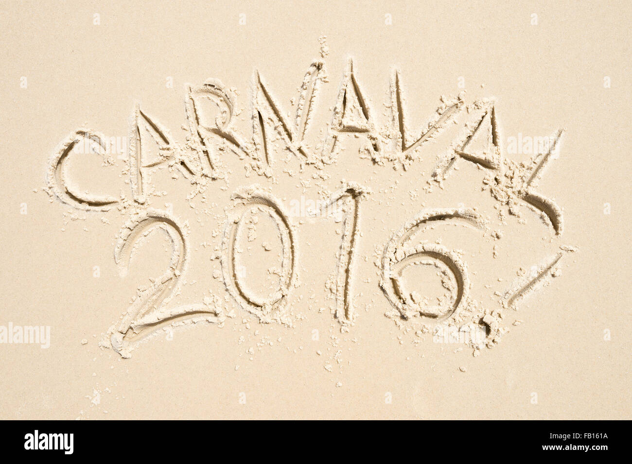 Carnival 2016 message handwritten in smooth sand on Ipanema Beach in ...