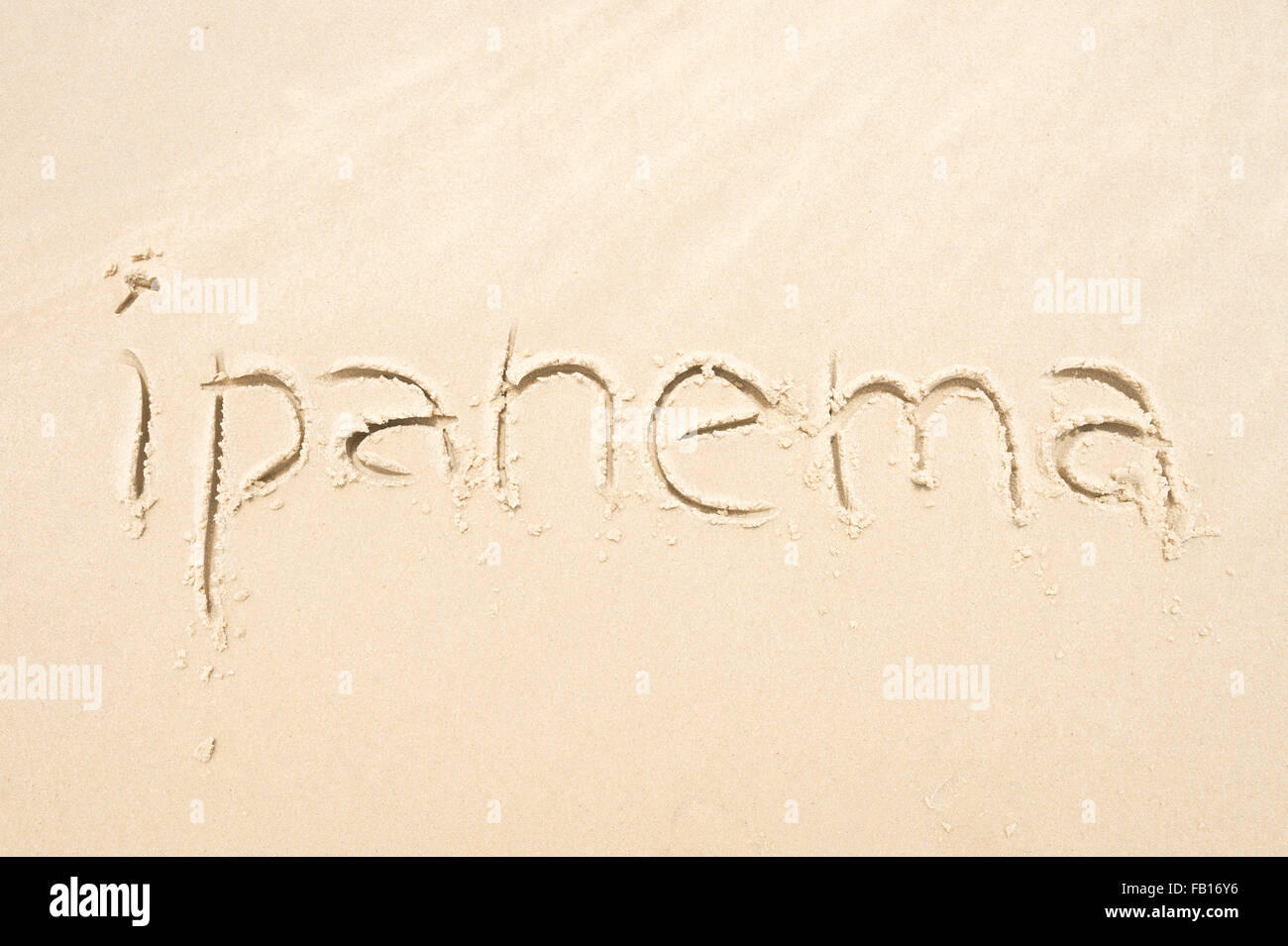 Ipanema, the famous beach, message handwritten on smooth sand in Rio de ...