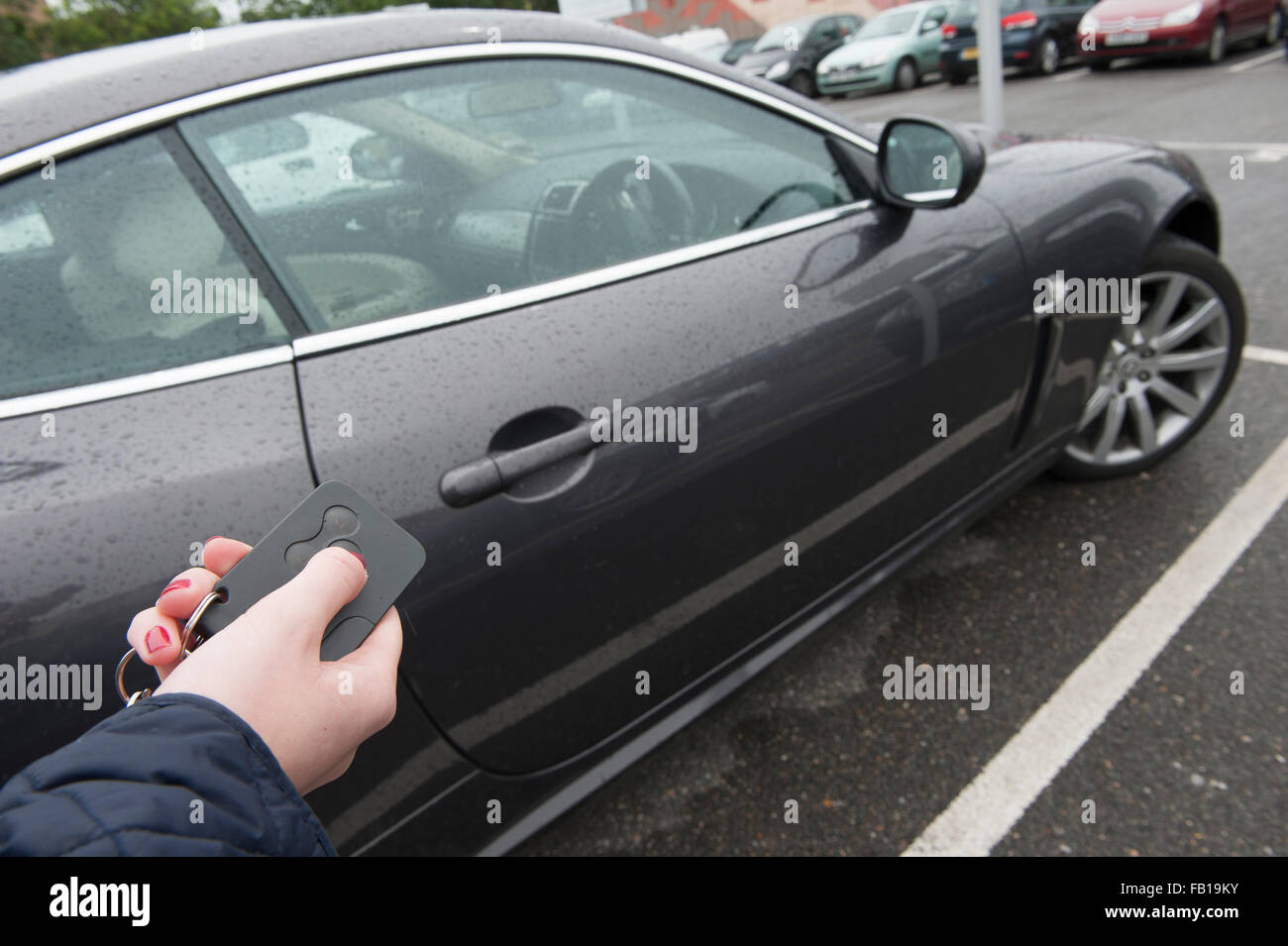 Person unlocking a car with a keyless fob Stock Photo - Alamy