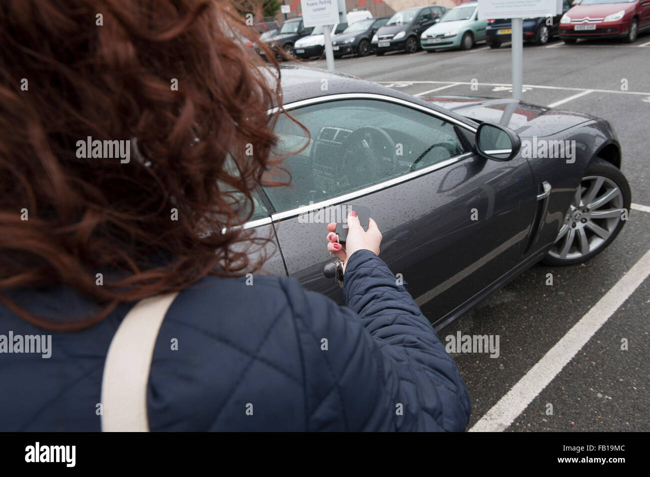 Person unlocking a car with a keyless fob Stock Photo - Alamy