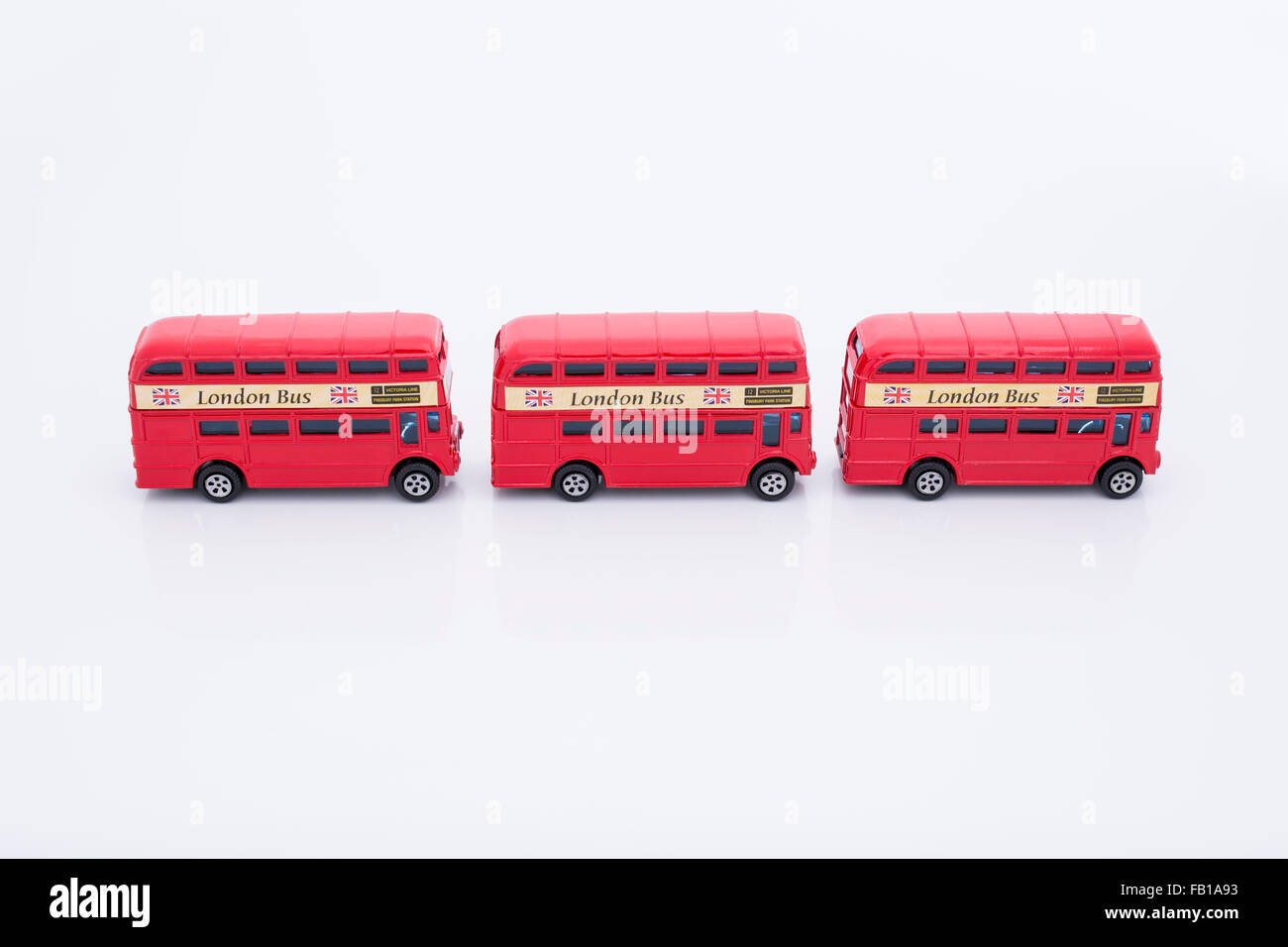 Three toy (die cast) London buses lined up. Metaphor for getting around ...