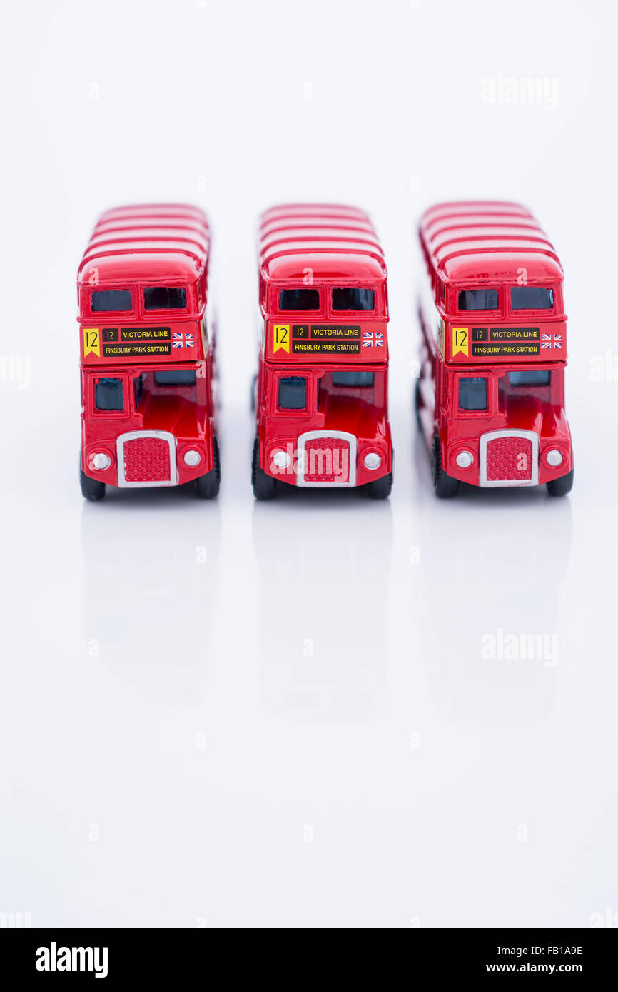 Three toy (die cast) London buses in a row. Metaphor for getting around ...