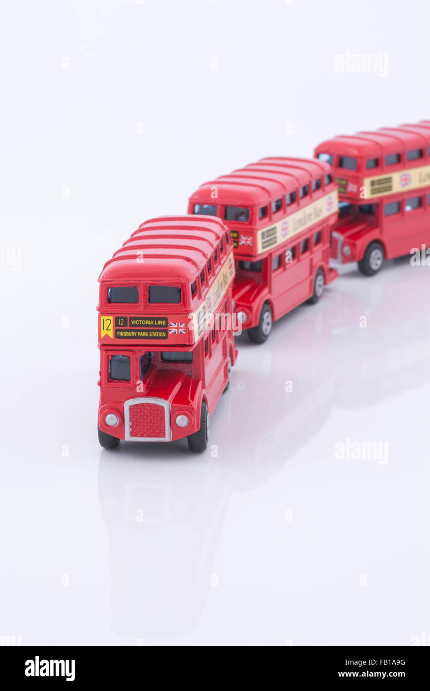 Three toy (die cast) London buses in a row. Metaphor for getting around ...