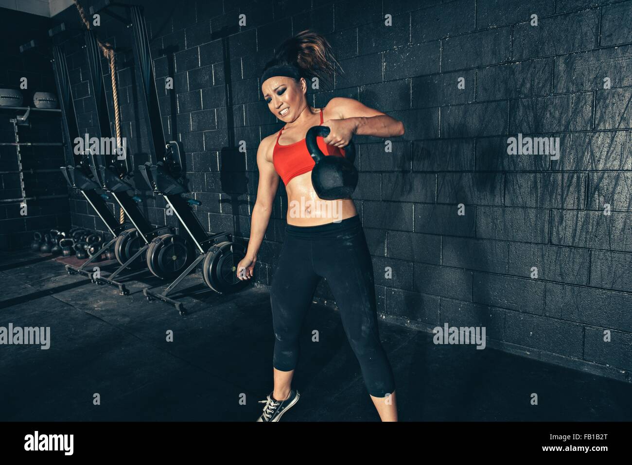 Girl lifting up weights in gym hi-res stock photography and images - Alamy