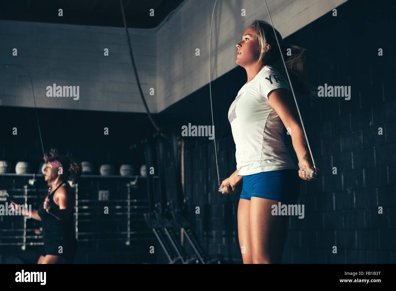 Women skipping with skipping ropes in gym Stock Photo - Alamy