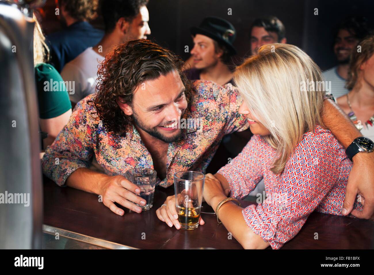 Young couple chatting in club Stock Photo - Alamy