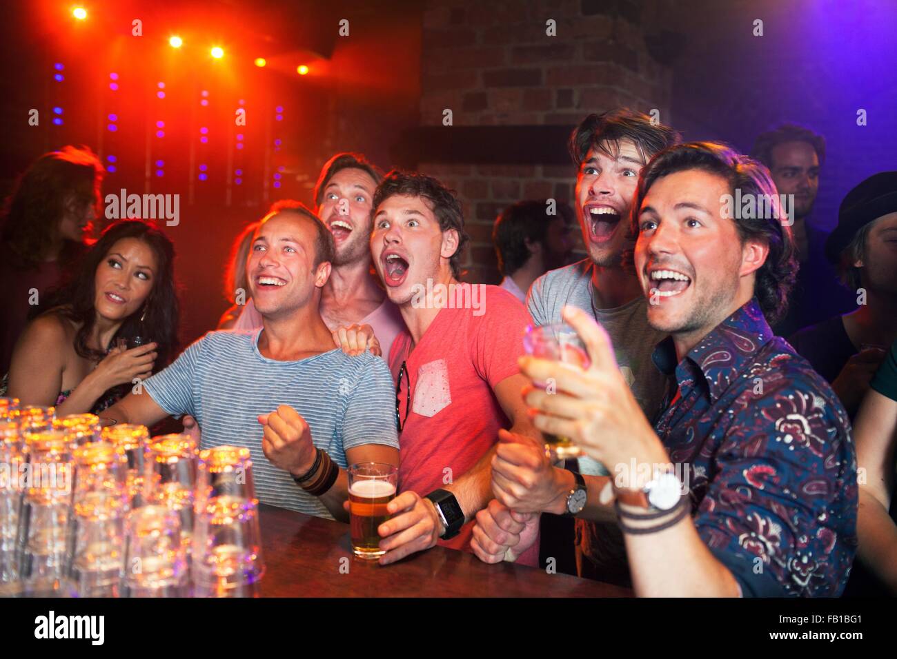 Group of friends celebrating in club Stock Photo - Alamy