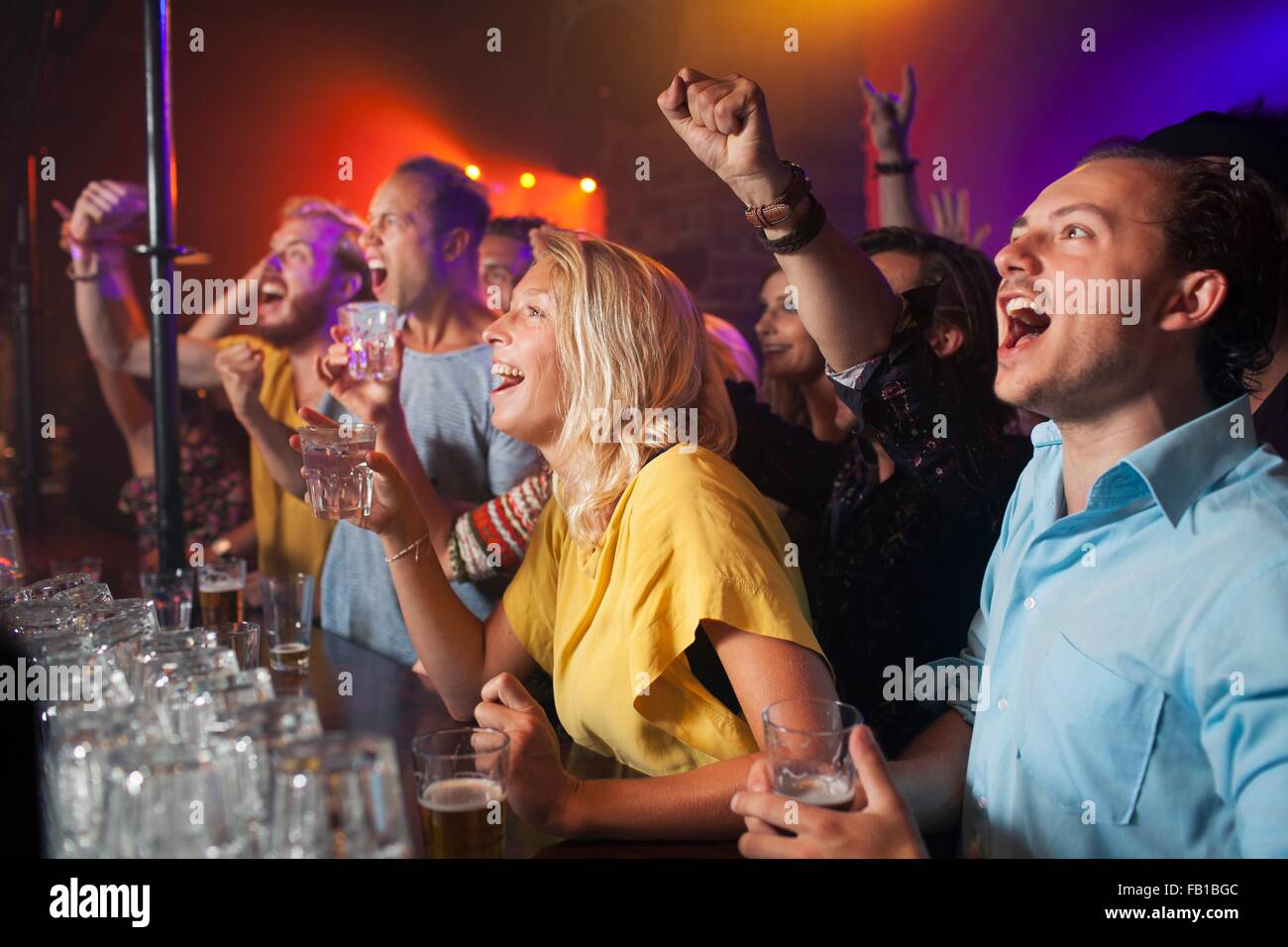 Group of friends watching performance in club Stock Photo - Alamy