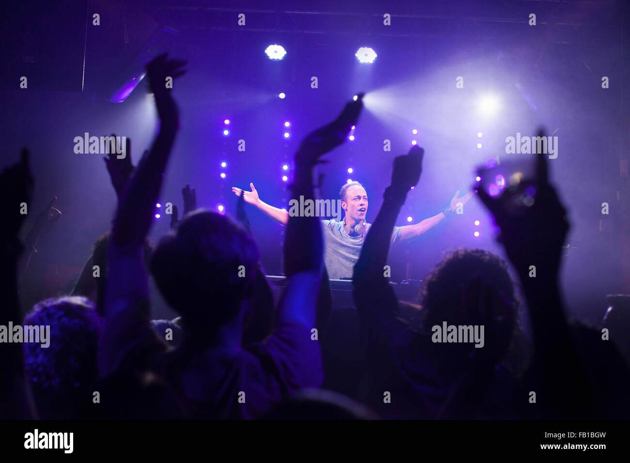 Group of friends watching DJ in club Stock Photo - Alamy