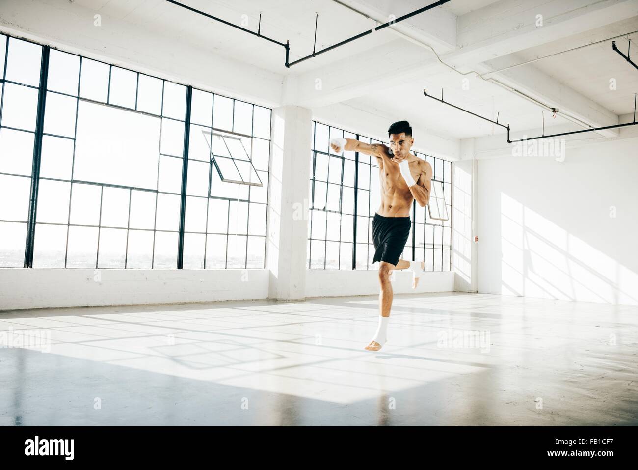 Full length front view of young man in gym in boxing stance Stock Photo ...