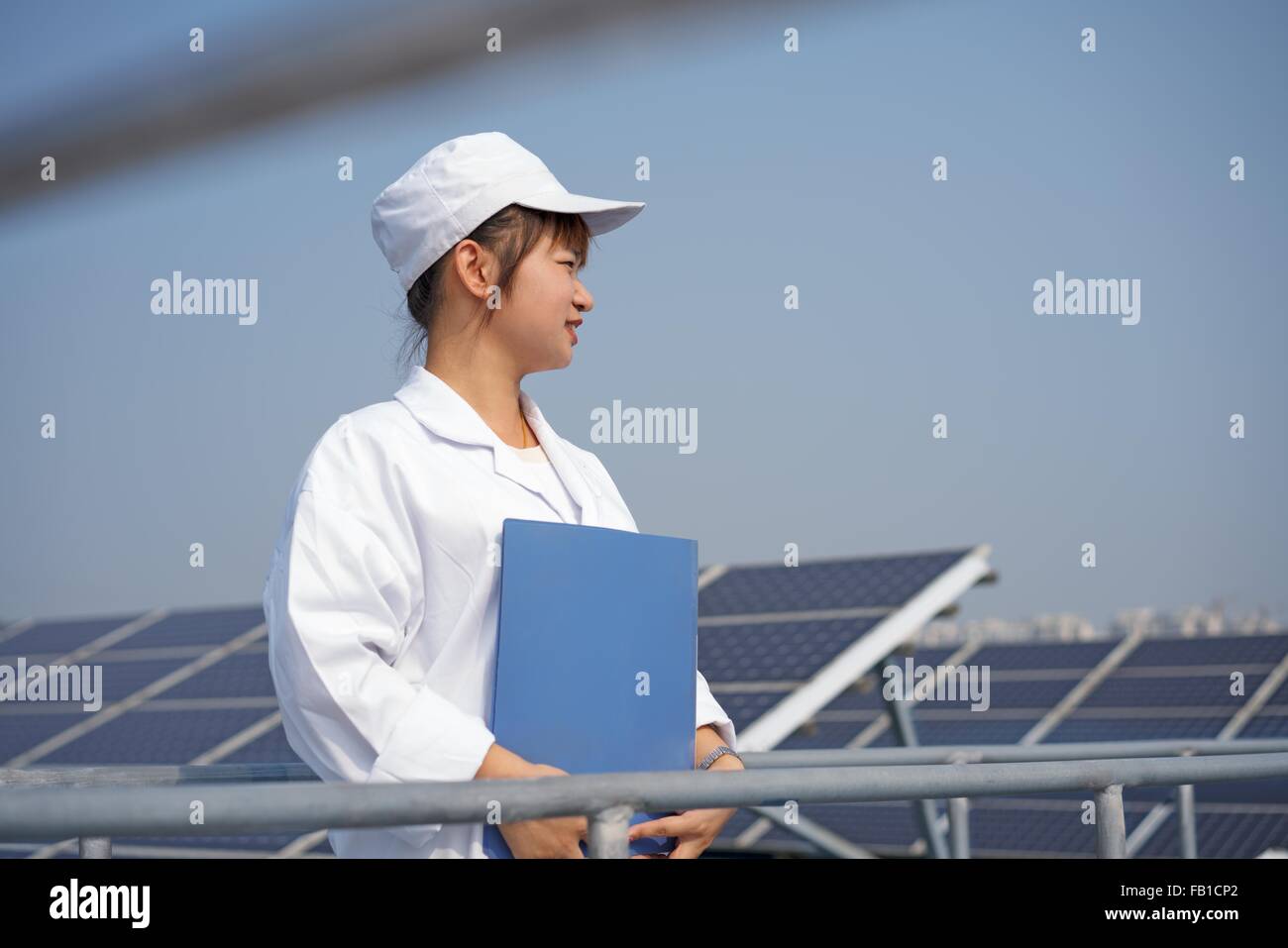Female worker on roof of solar panel assembly factory, Solar Valley ...
