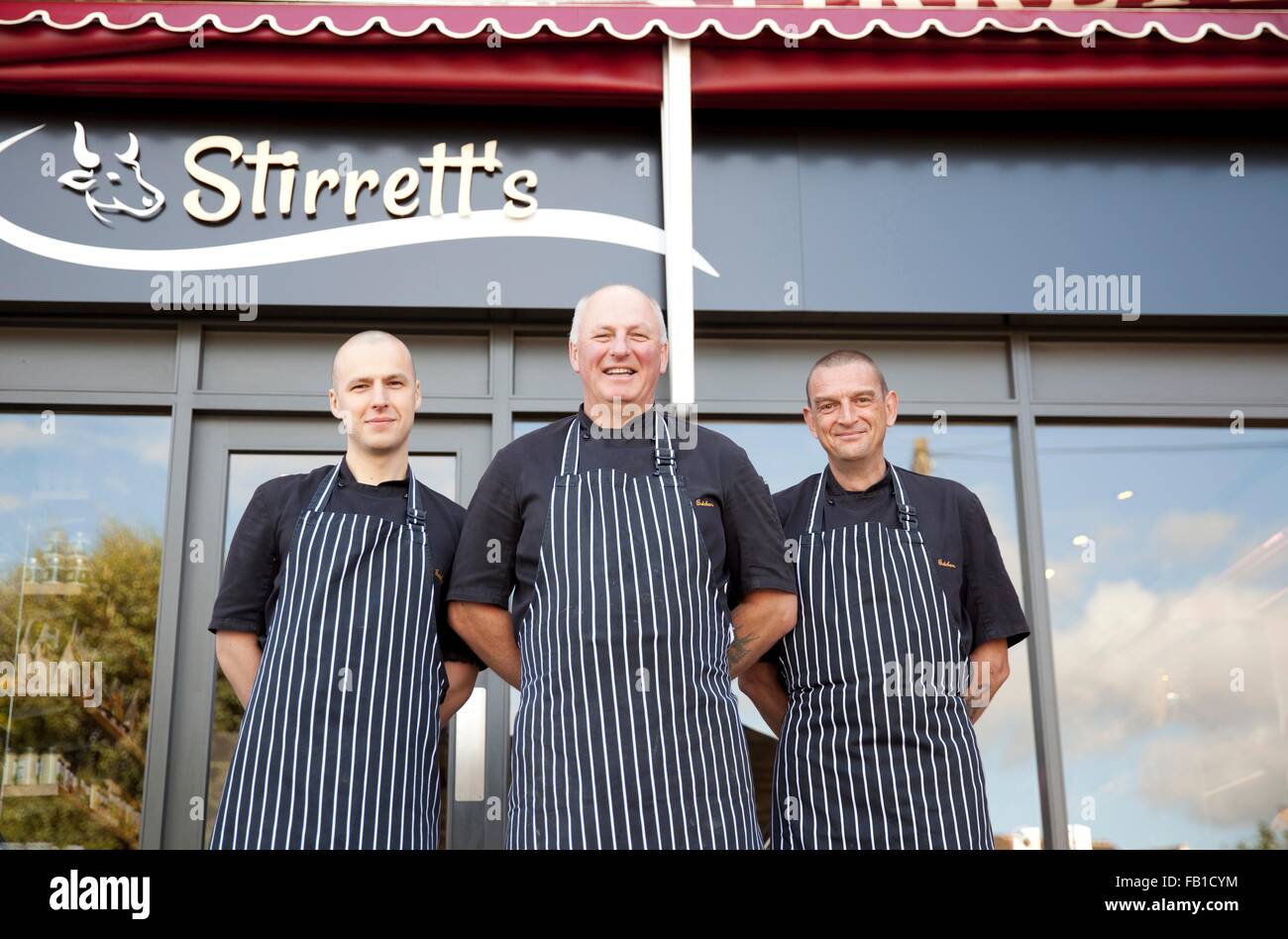 Portrait of three male butchers outside butchers shop Stock Photo - Alamy