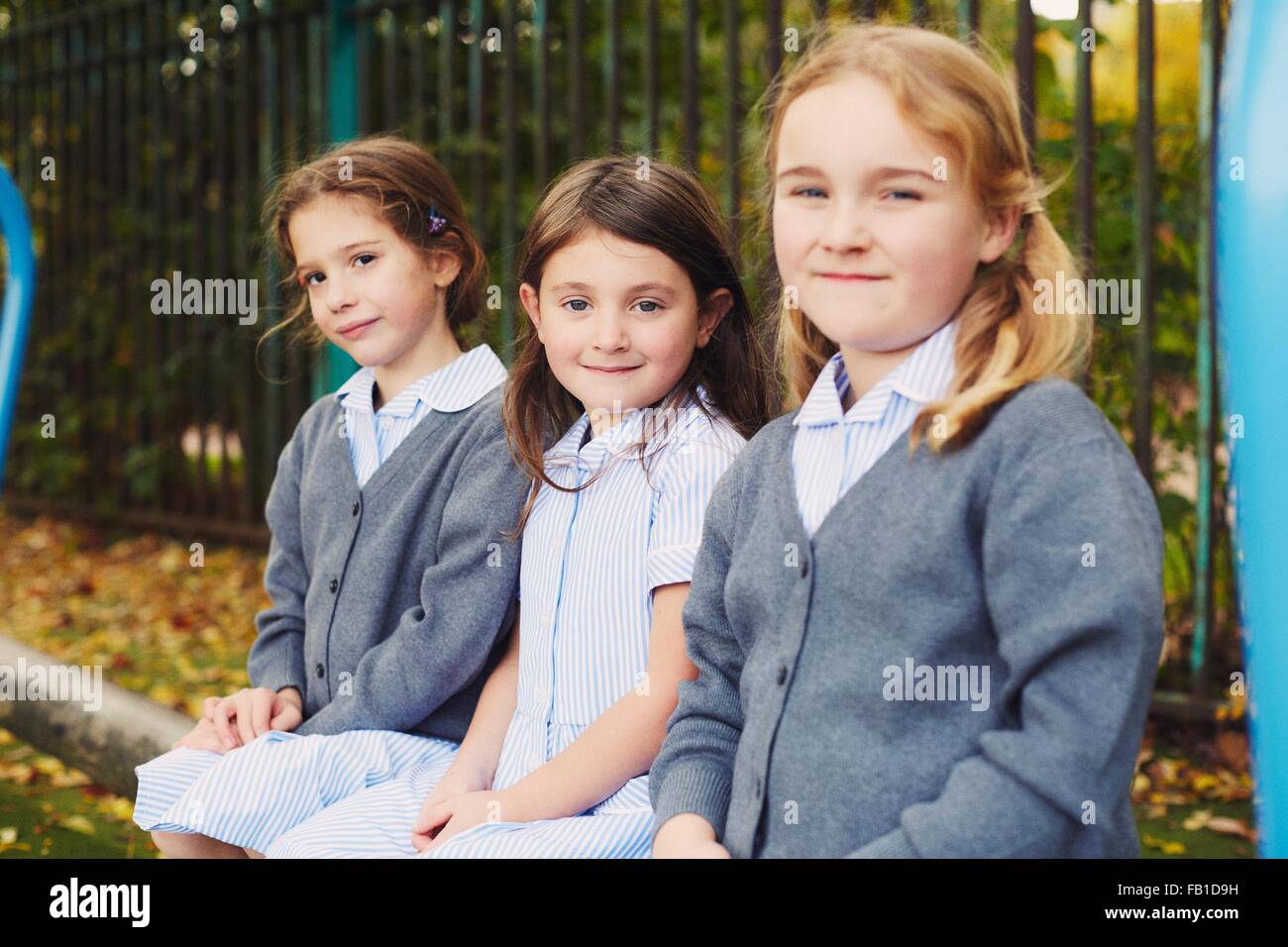 Portrait of three elementary schoolgirls in playground Stock Photo - Alamy