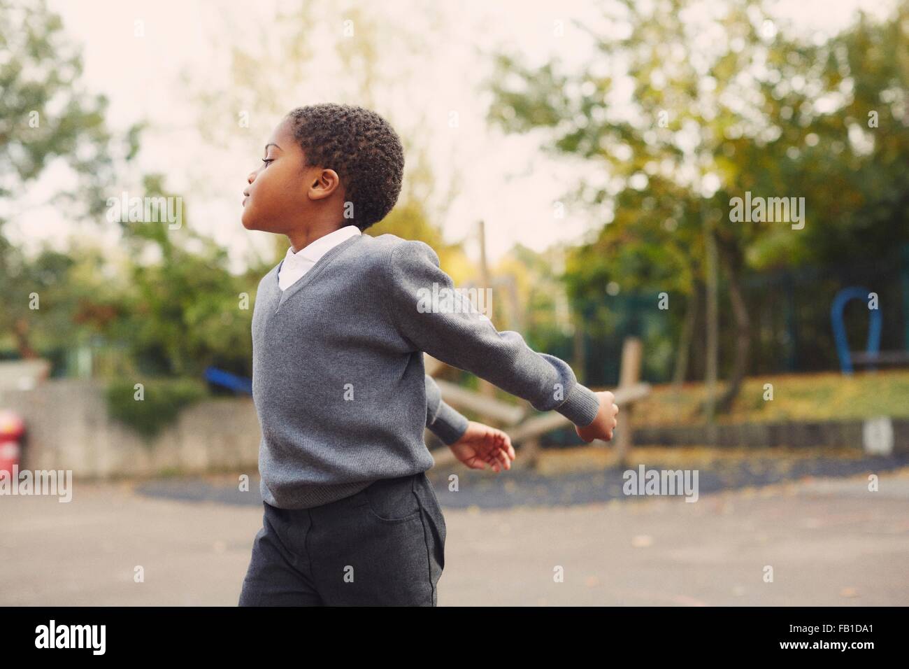 Elementary schoolboy running in playground Stock Photo - Alamy
