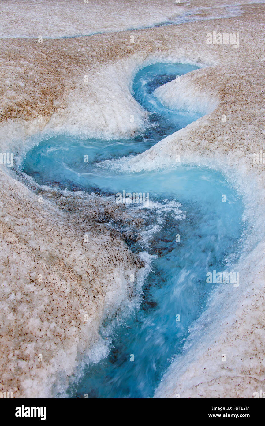 Supraglacial / surface meltwater flowing through sinuous channel on ...