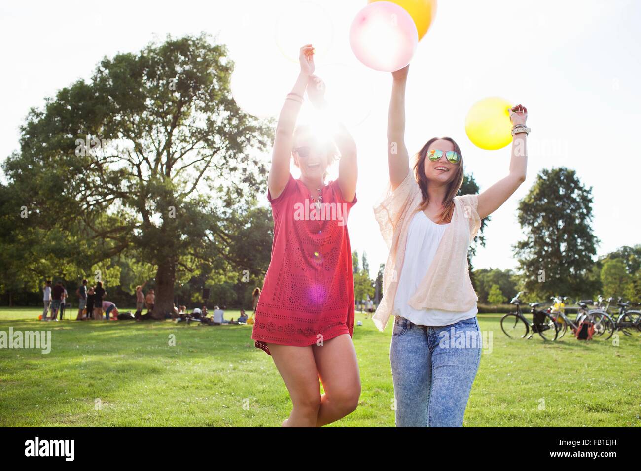 Two young women dancing with balloons at park party Stock Photo - Alamy