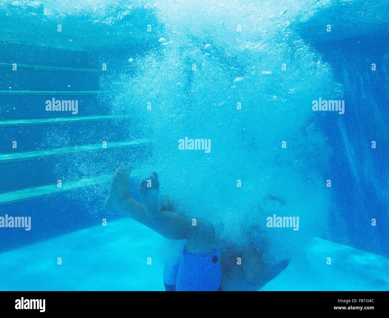 Underwater view of boy sinking to bottom of swimming pool Stock Photo ...