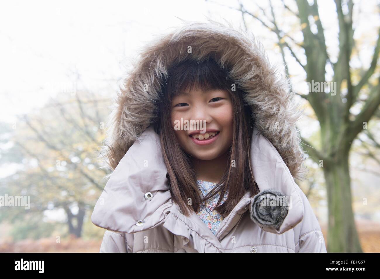 Portrait of young girl wearing winter coat, smiling Stock Photo - Alamy