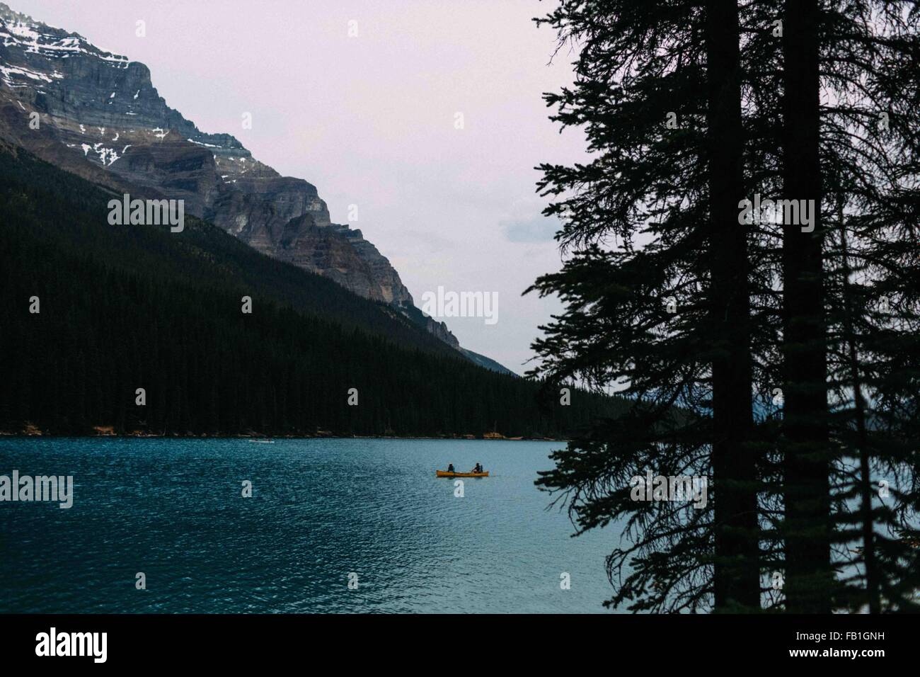 Couple in canoe on Moraine lake, looking at camera, Banff National Park ...