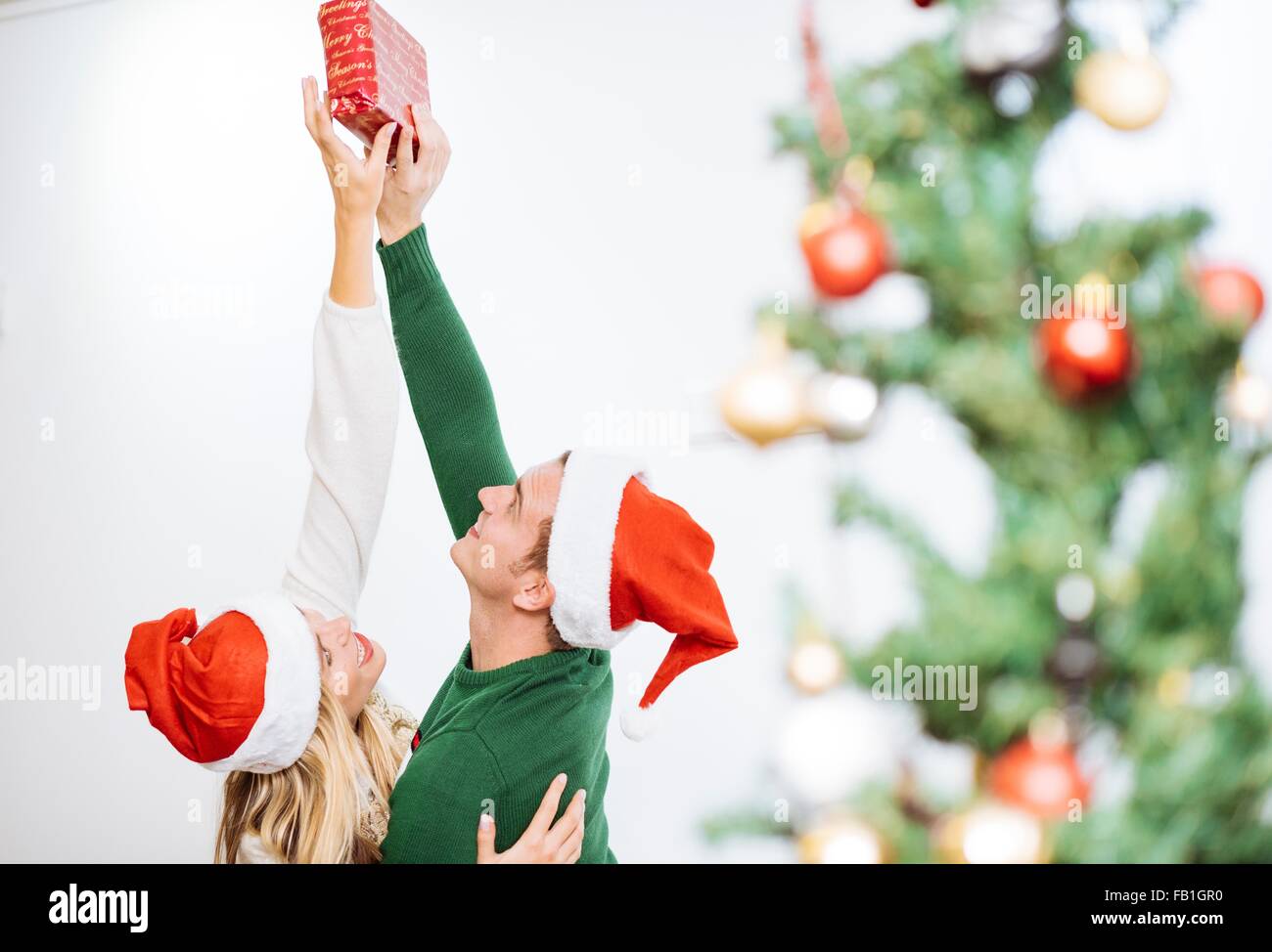 Young couple holding present hi-res stock photography and images - Alamy