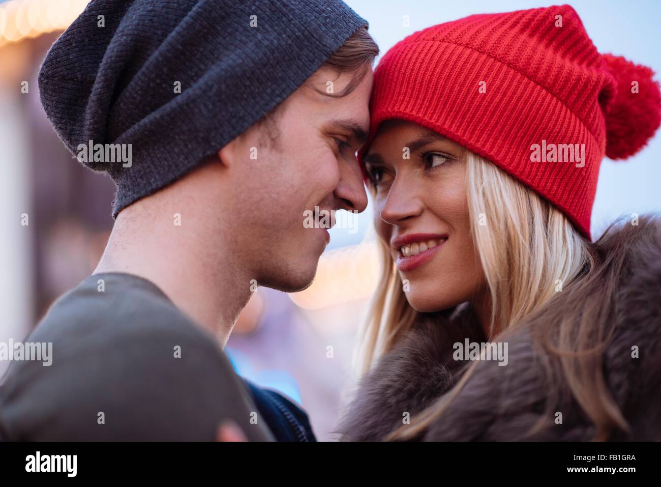 Head and shoulder shot of romantic young couple wearing knit hats Stock ...