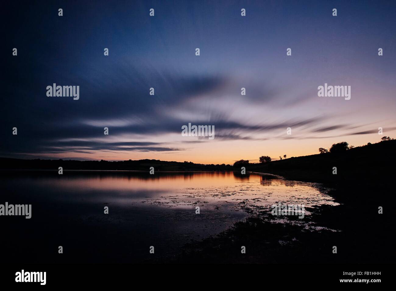 Wimbleball lake, Exmoor at sunset, UK Stock Photo - Alamy