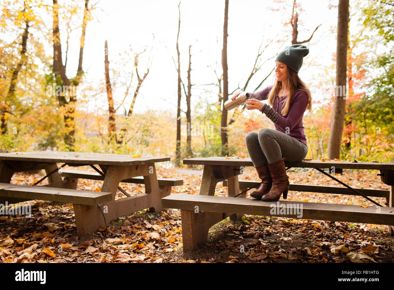 Young woman sitting picnic bench hi-res stock photography and images ...