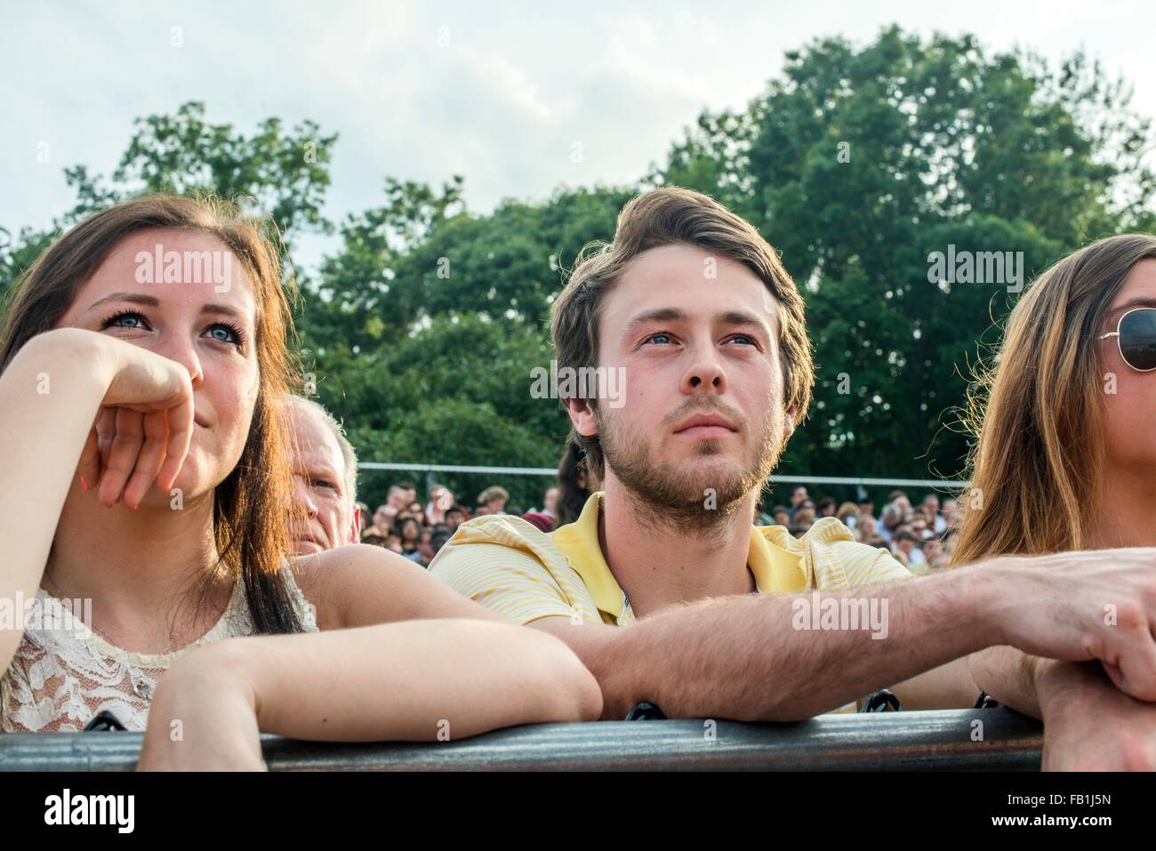 Young man and sisters watching graduation ceremony Stock Photo - Alamy