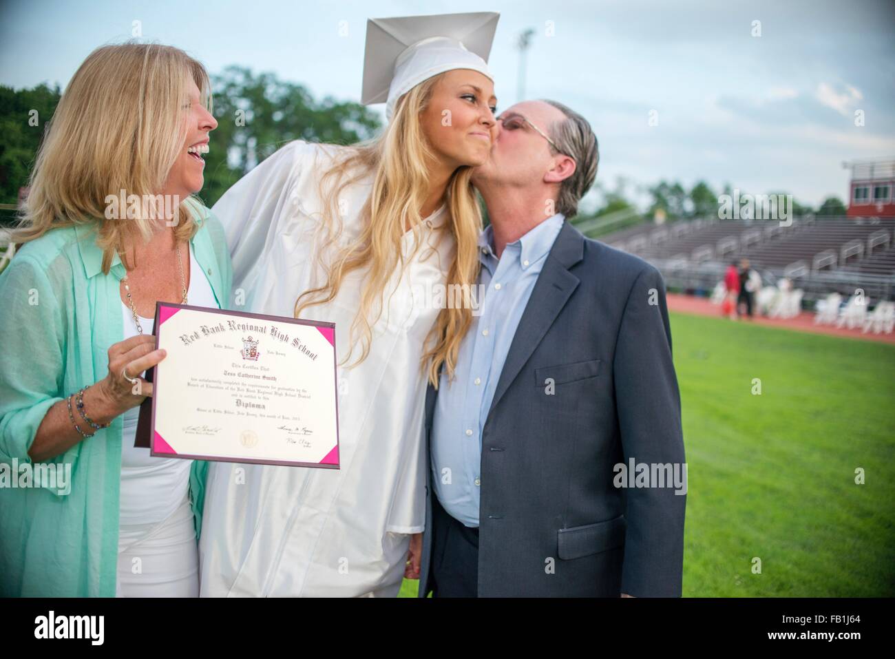 Father kissing graduate daughter at graduation ceremony Stock Photo - Alamy