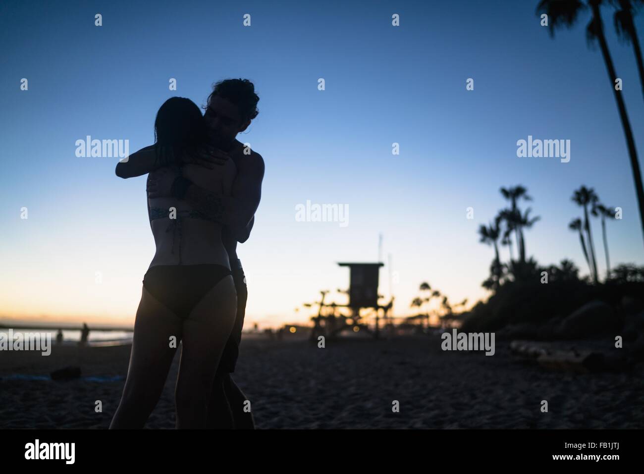 Romantic young couple hugging at sunset, Newport Beach, California, USA ...
