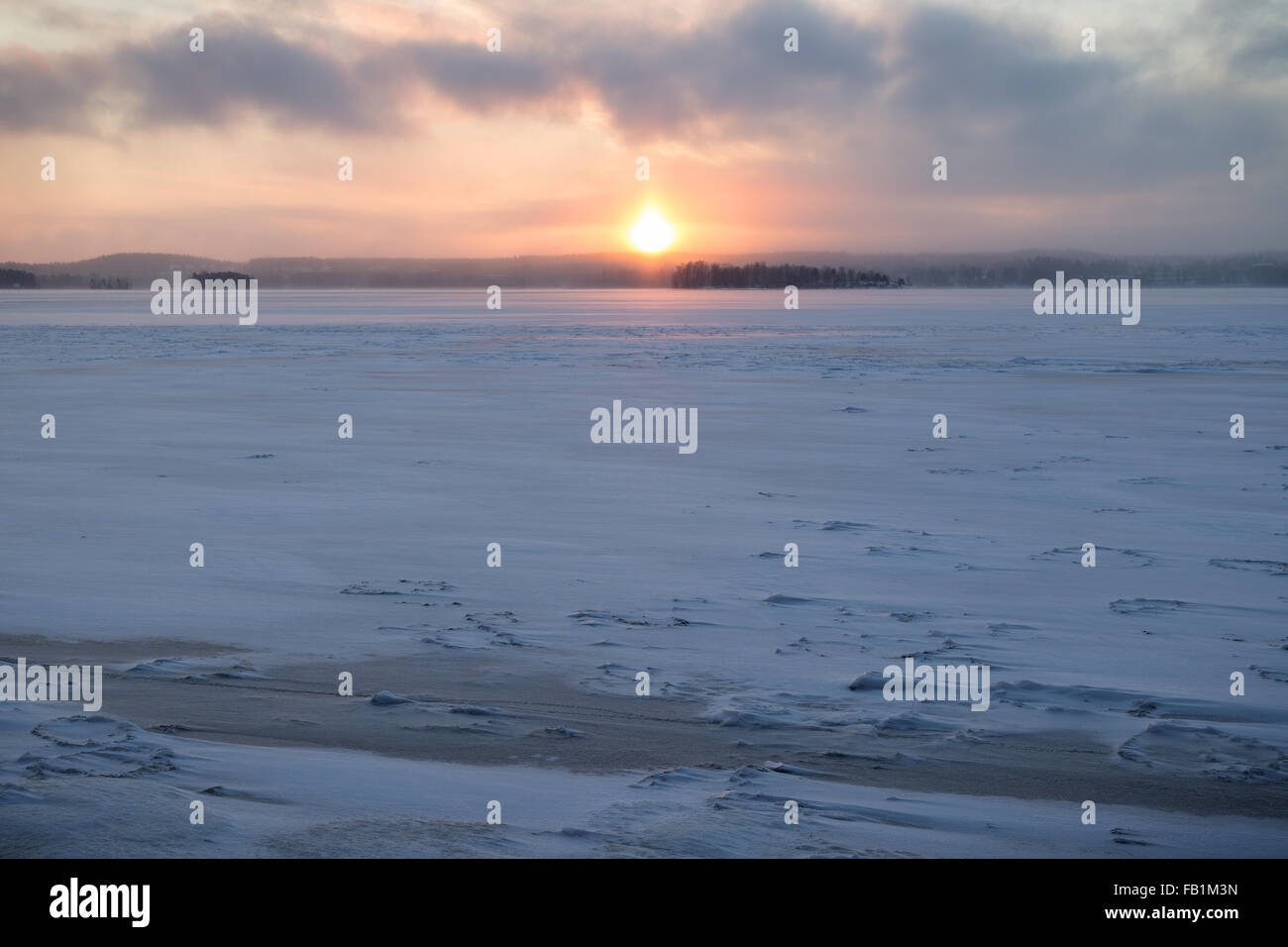 Frozen and snowy lake and sunrise in Tampere, Finland, in the winter ...