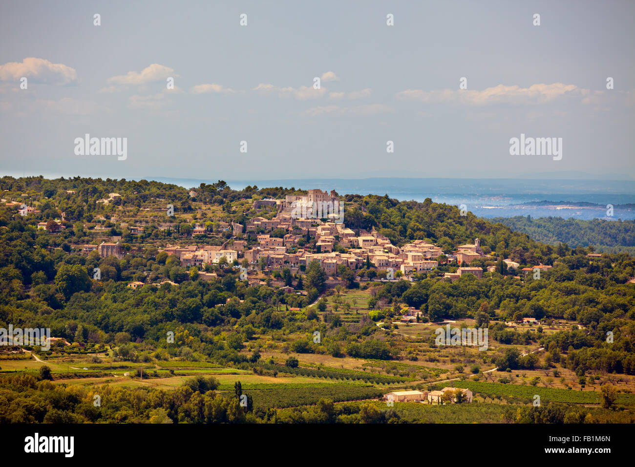 Landscape with a Castle ruins on a hill above the village in Provence ...