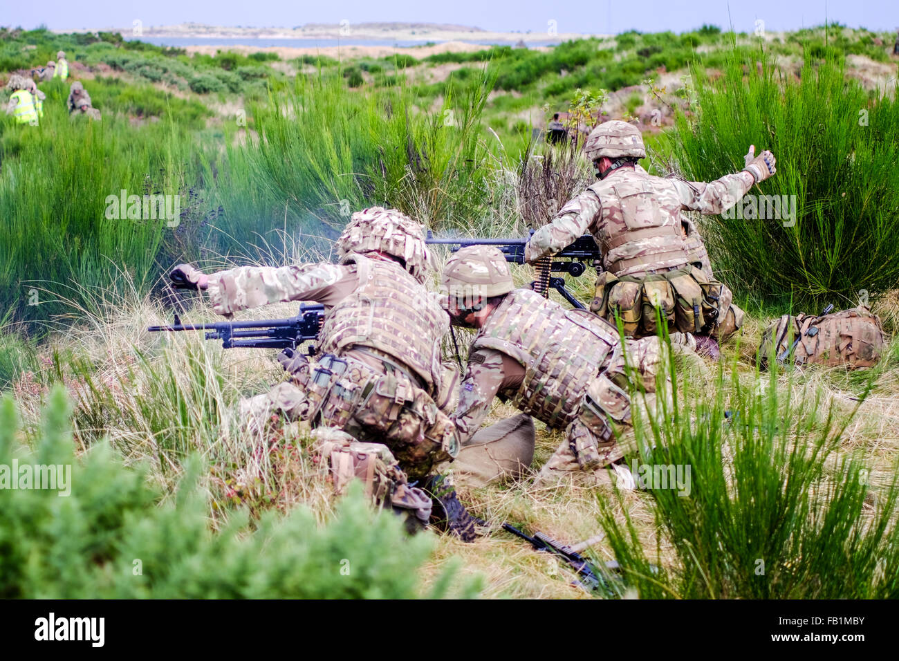 British Royal Air Force regiment soldiers shoot machine guns in a ...