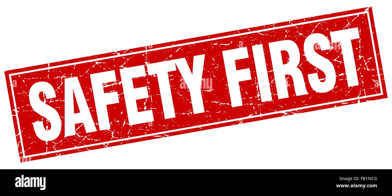 safety first red square grunge stamp on white Stock Photo - Alamy