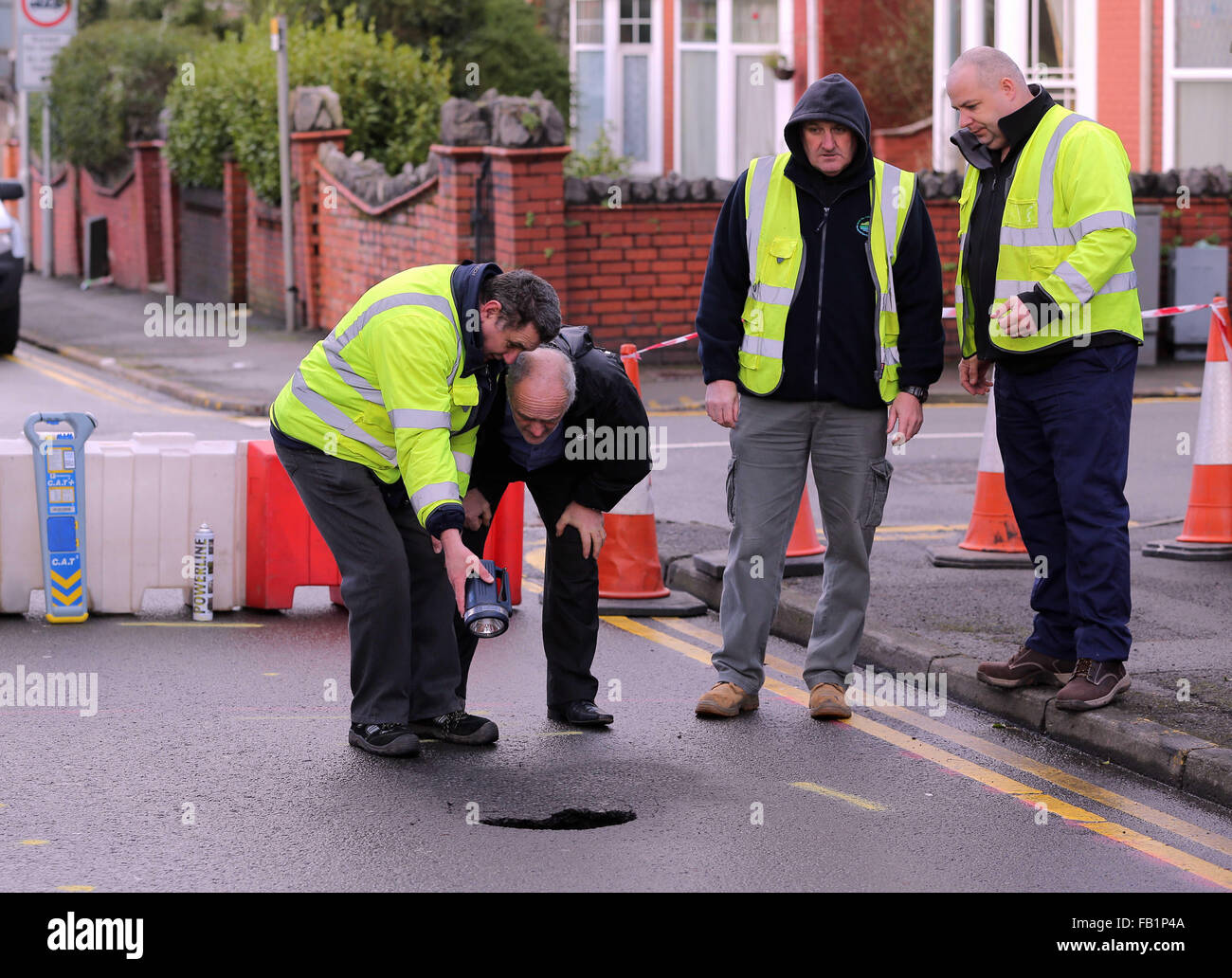 Neath, UK. Thursday 07 January 2016 Council officials by the sinkhole ...