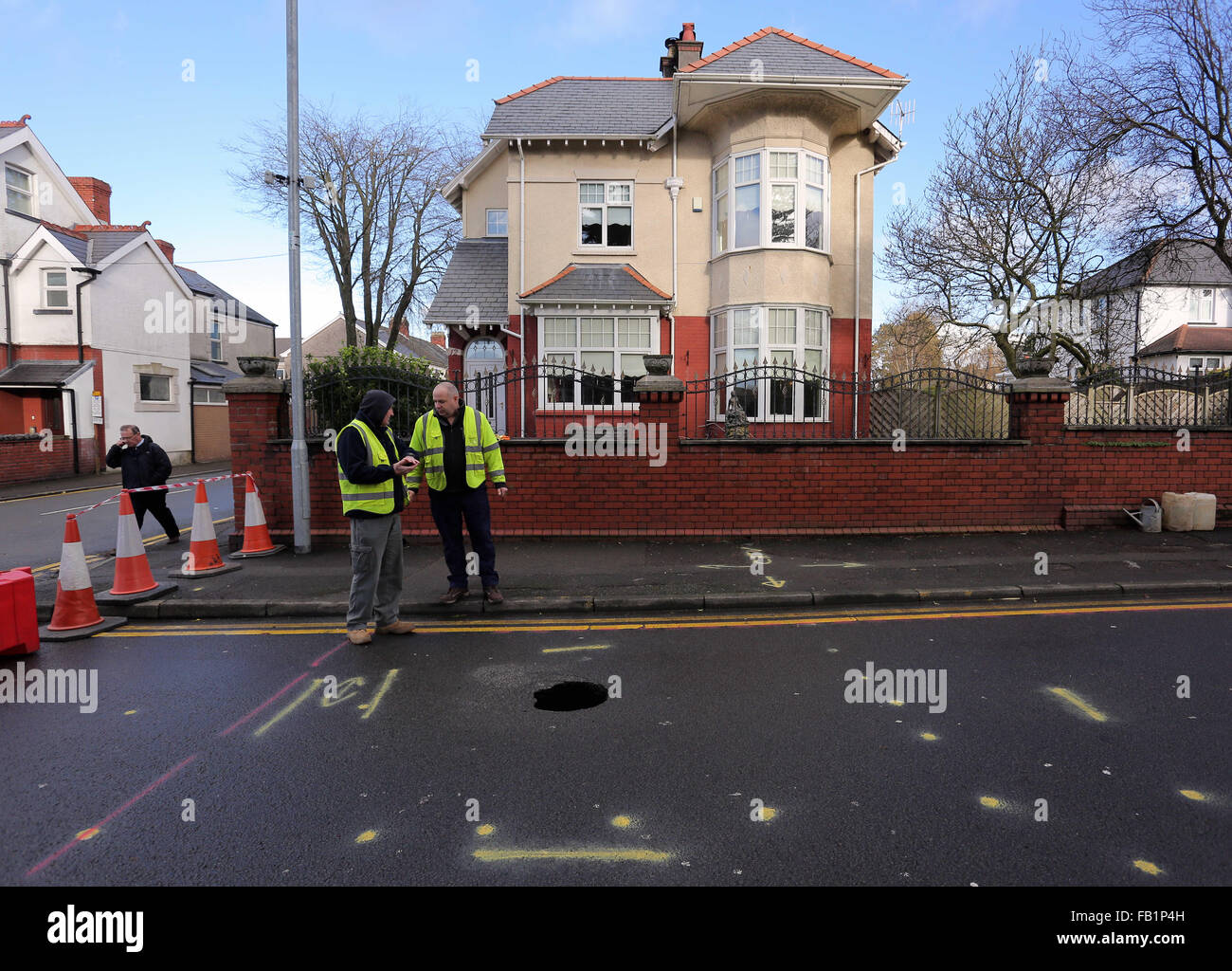 Neath, UK. Thursday 07 January 2016 Council officials by the sinkhole ...