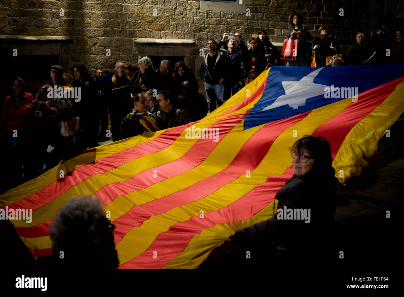 Barcelona, Spain. 7th January, 2016. People wave a giant estelada flag (symbol of catalan ...